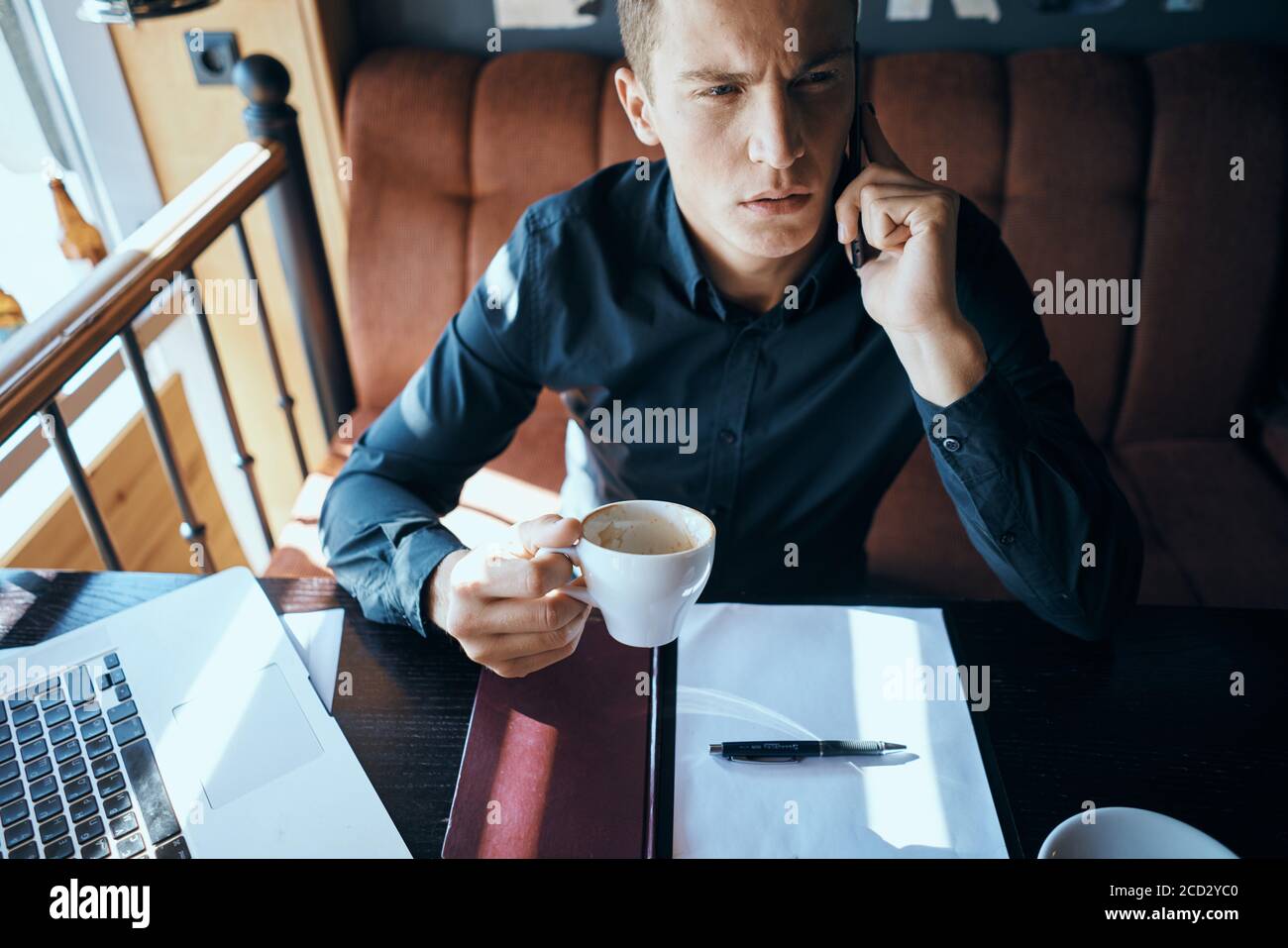 Business man with a cup of coffee in a cafe emotions work in the office ...