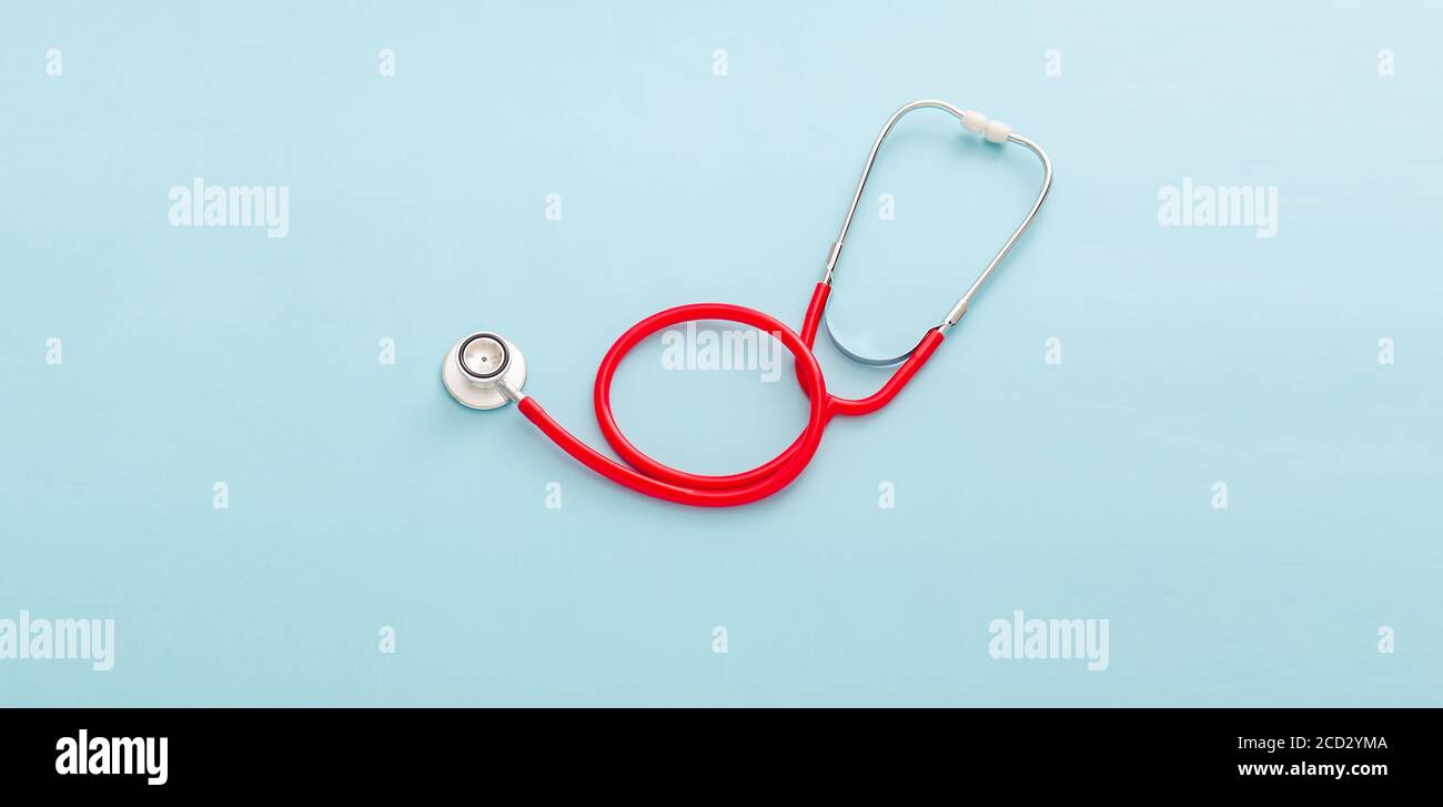 Red stethoscope on blue color background. Concept of medicine and ...