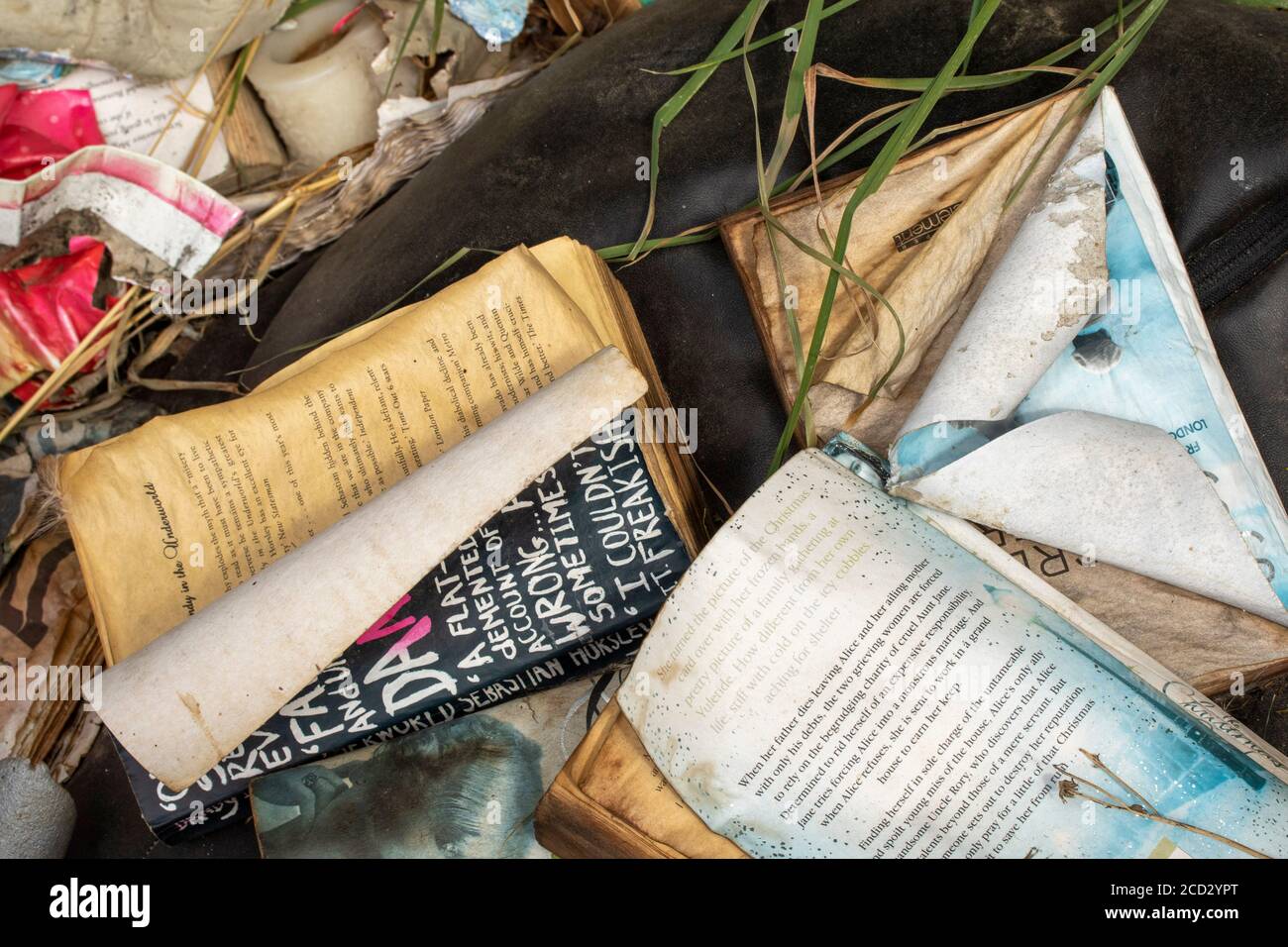 Casually discarded household waste littering an alleyway, environmental ...
