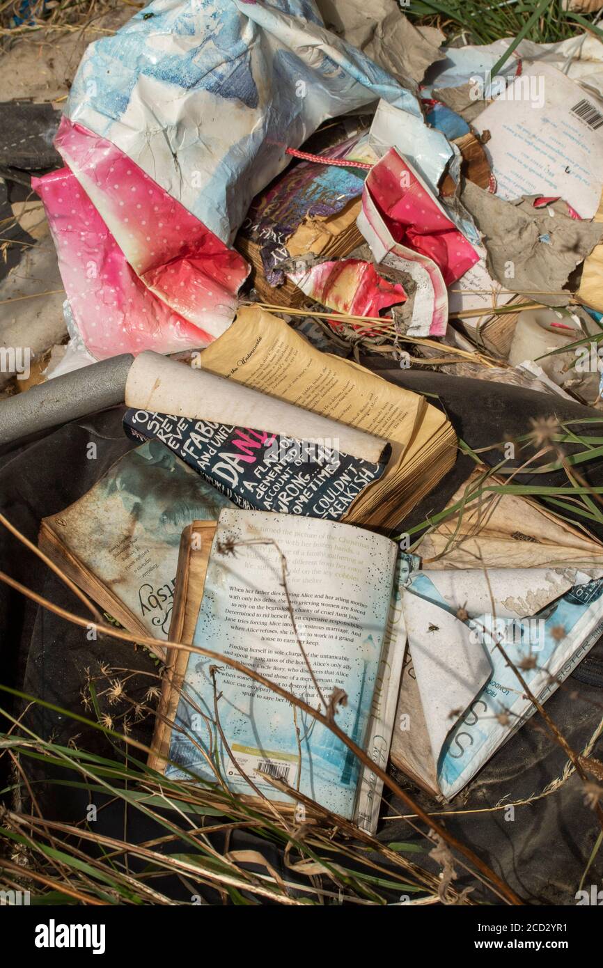 Casually discarded household waste littering an alleyway, environmental ...