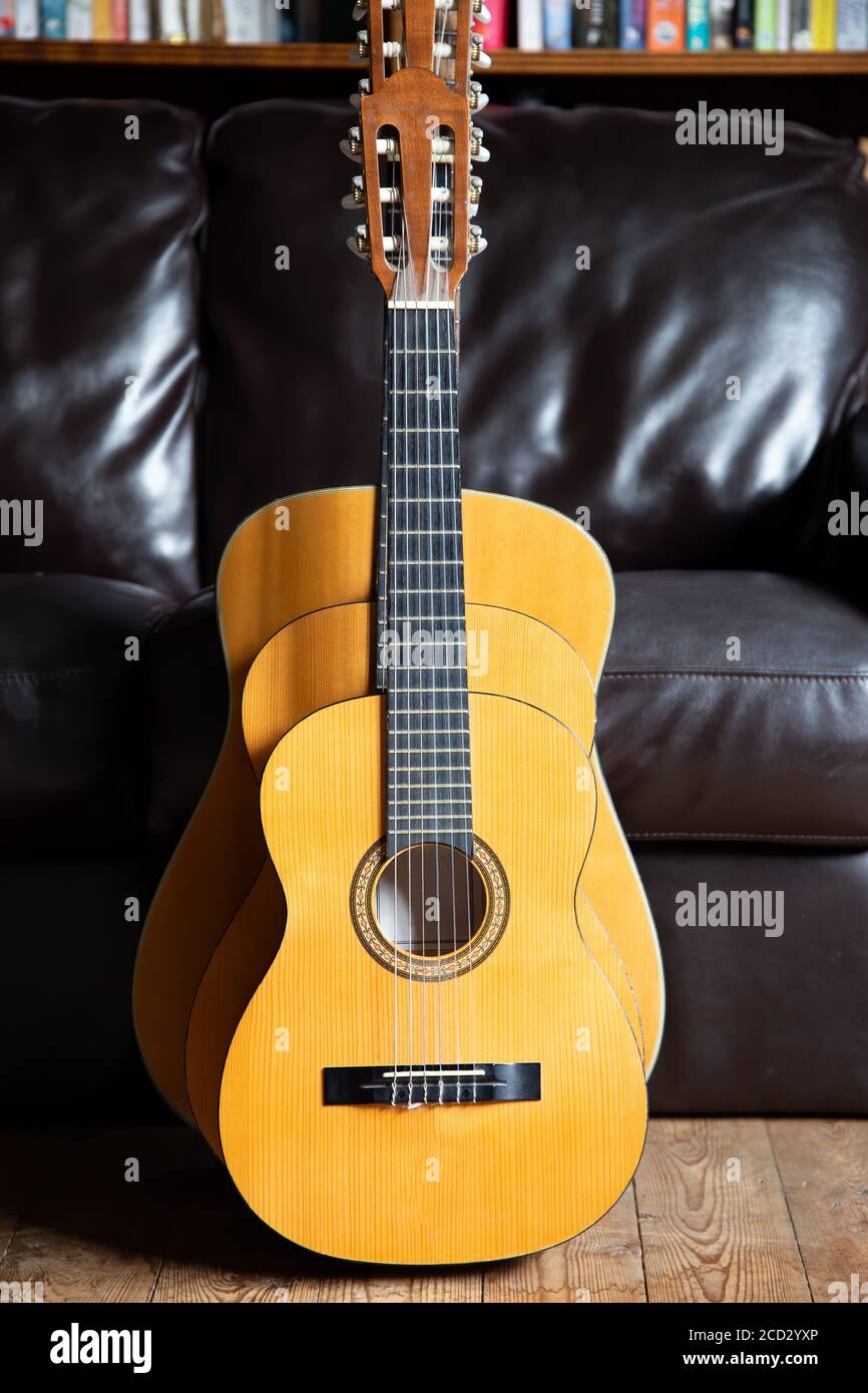 Three guitars, in several sizes, aligned vertically in a residential ...