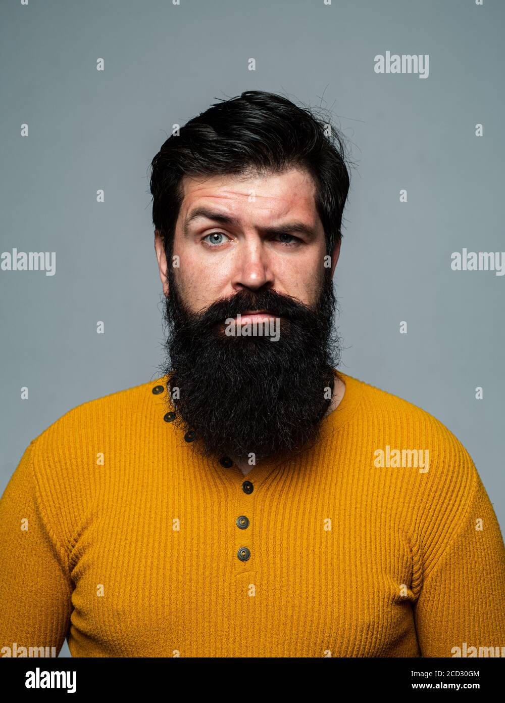 Serious man has beard and mustache, looks seriously Stock Photo - Alamy