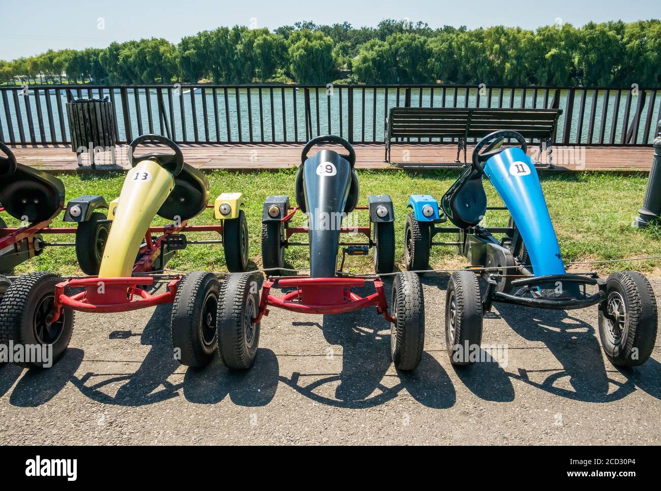Go-karts with pedals and wheels for rent.. Many aligned colored carts ...