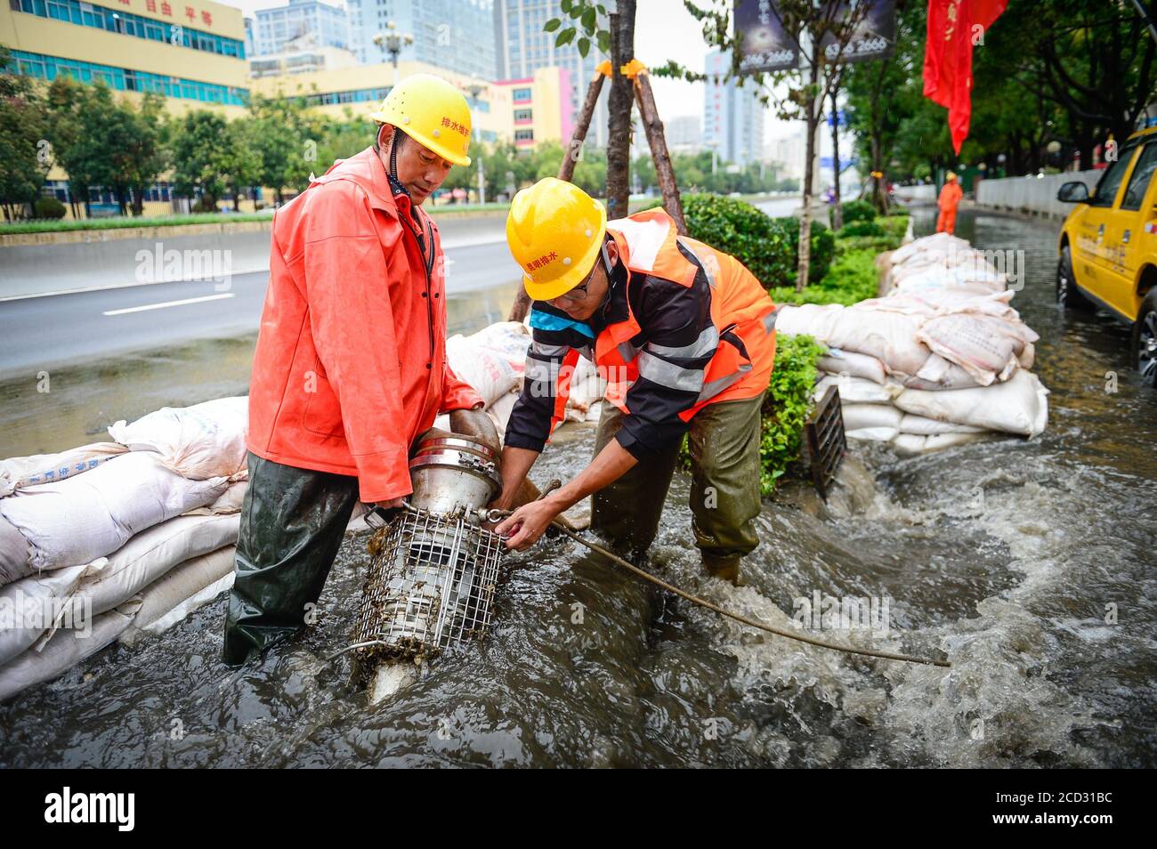 Staff from local sewage corporation are busy at discharging water which ...