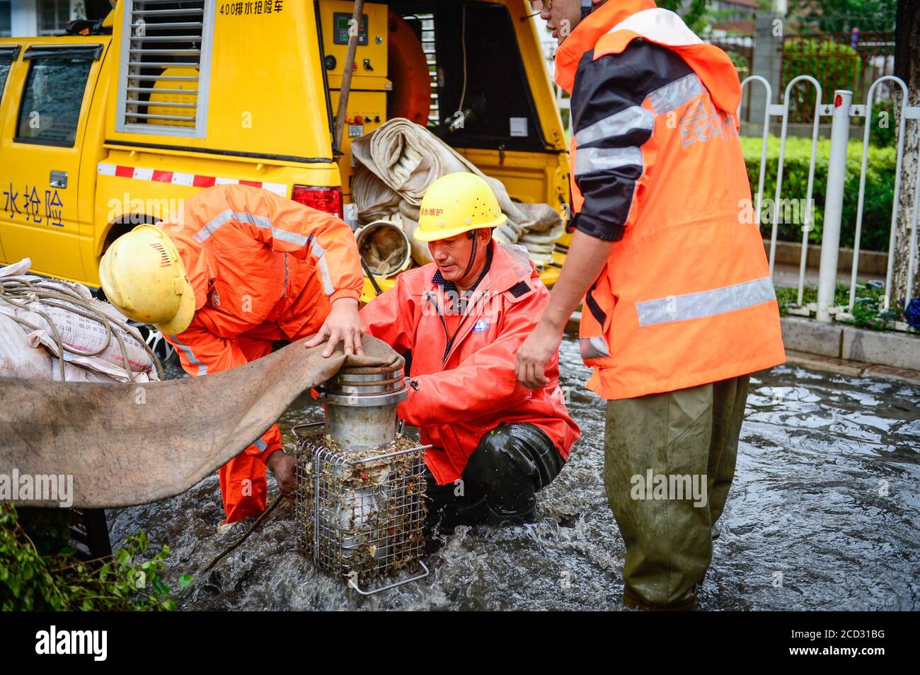 Staff from local sewage corporation are busy at discharging water which ...