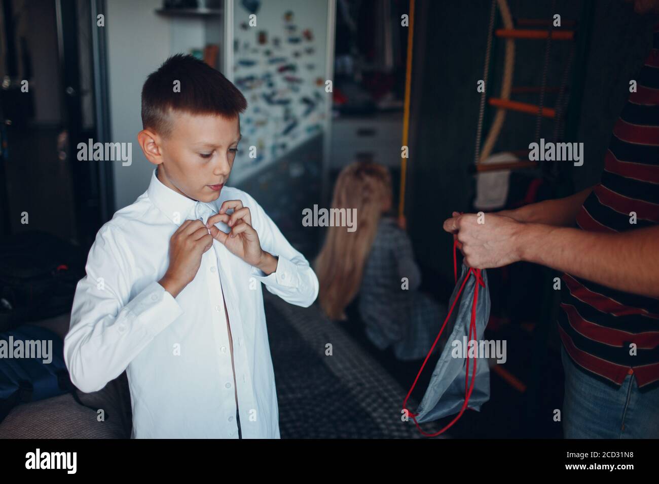 Child getting dressed for school hi-res stock photography and images ...