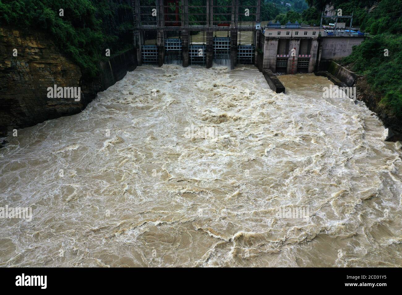 An aerial view of water gushing out of floodgate of a local ...