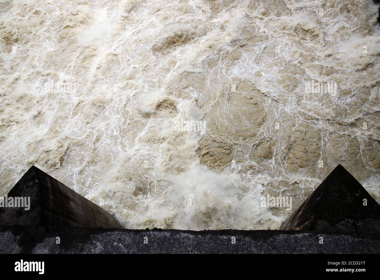 An aerial view of water gushing out of floodgate of a local ...