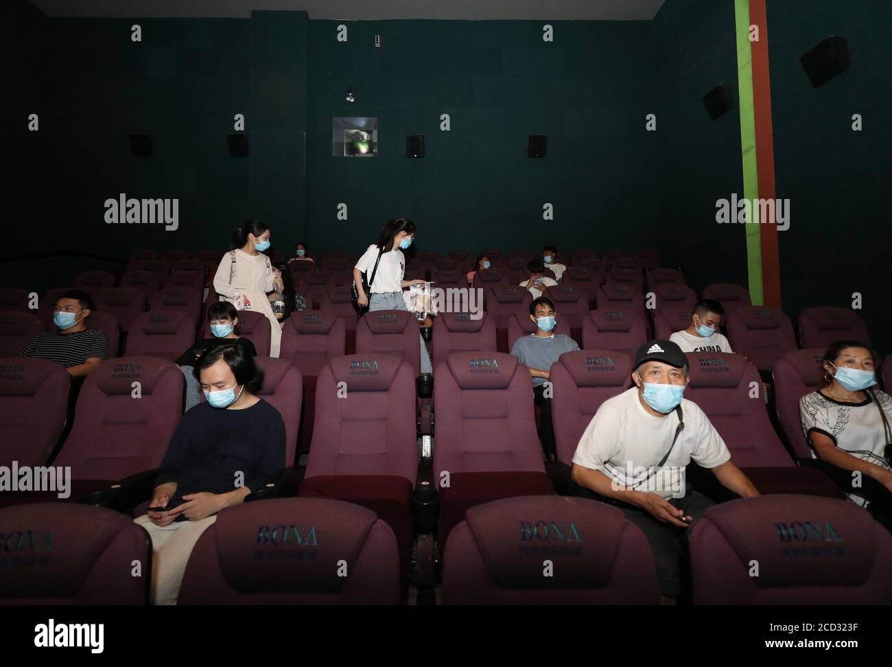 A large number of audience are seen in the cinema, purchasing tickets ...