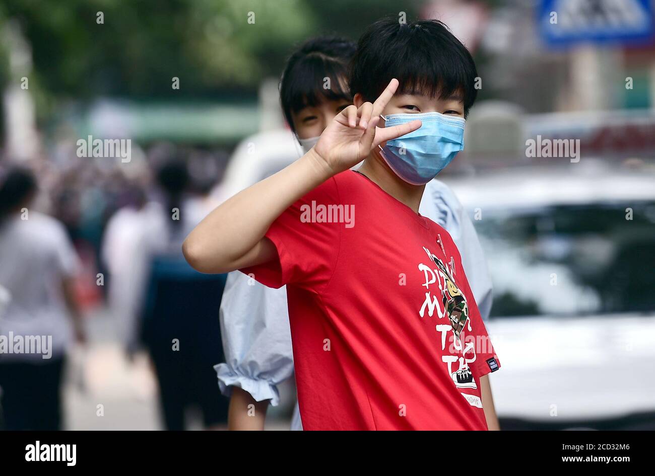 Students say goodbye to their families and teachers outside a testing ...