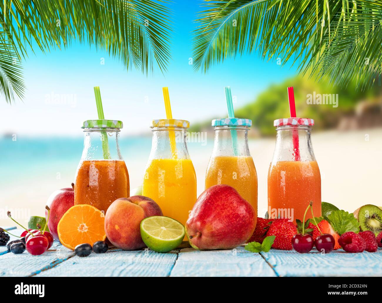 Fresh smoothie drinks placed on wooden planks, blur tropical beach on ...