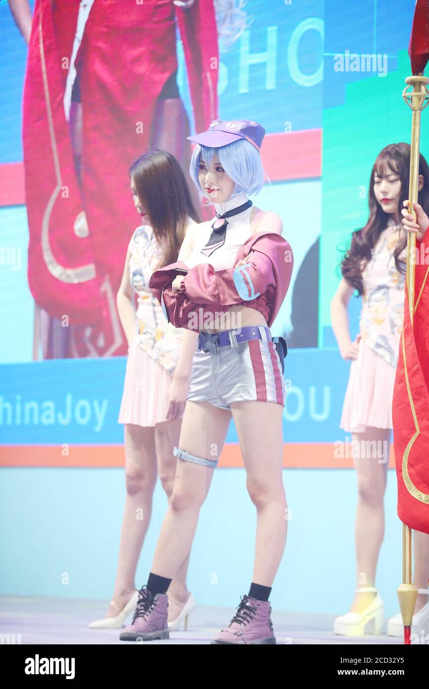 Beautiful cosplayers are seen posing and performing in clothes shown in ...