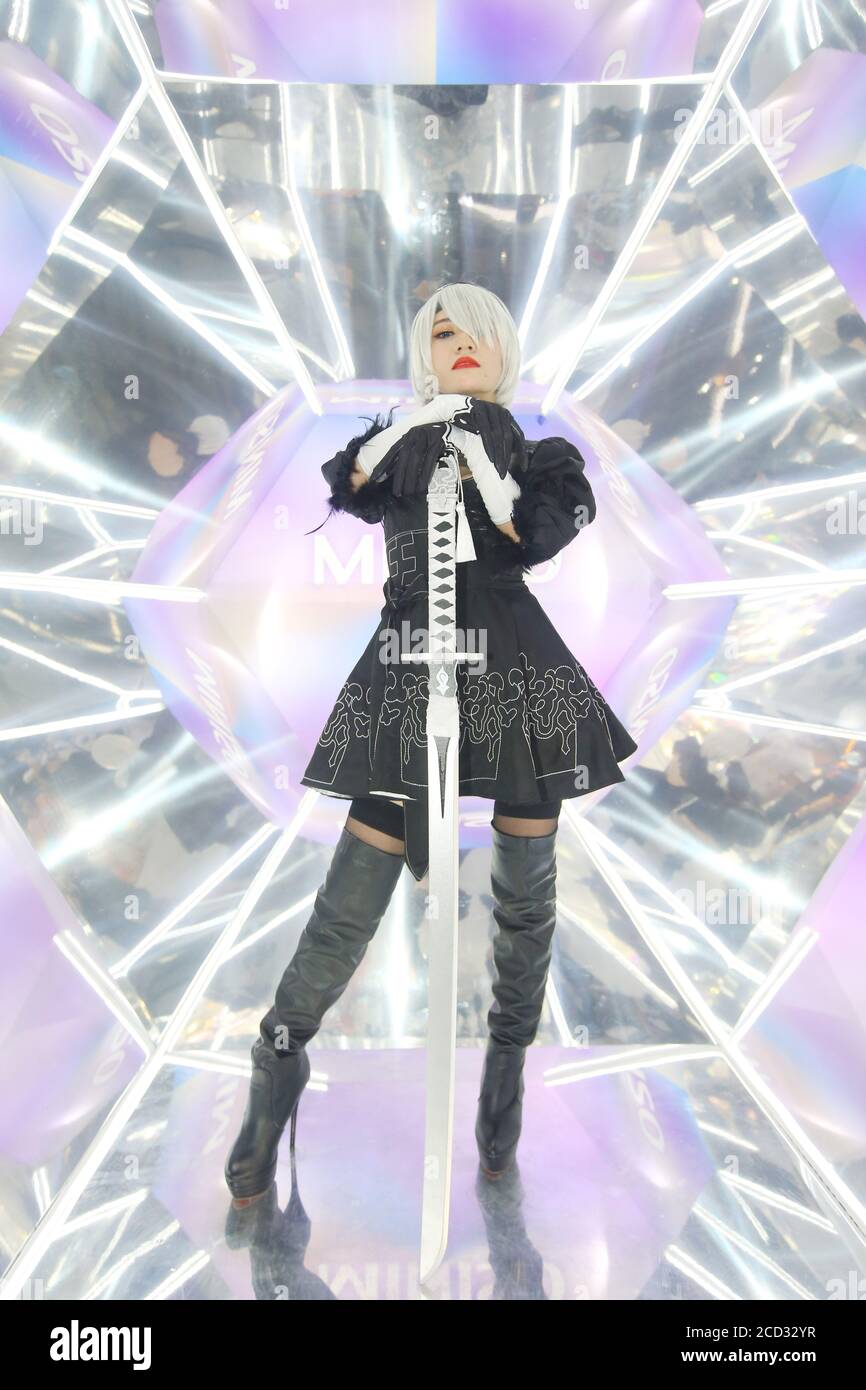 Beautiful cosplayers are seen posing and performing in clothes shown in ...