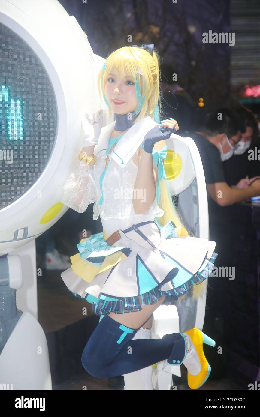 Beautiful cosplayers are seen posing and performing in clothes shown in ...