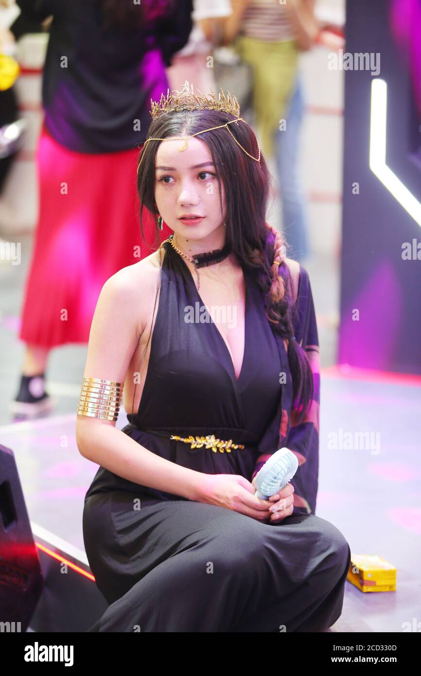 Beautiful cosplayers are seen posing and performing in clotThes shown ...