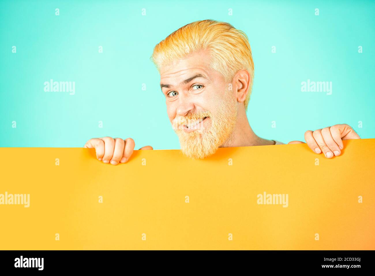 Close up portrait of man showing blank signboard with copyspace area ...