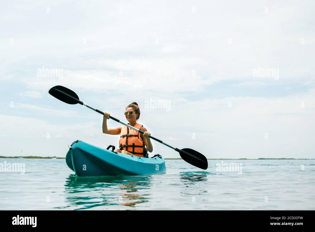 Happy young and beautiful woman kayaking in on the lake Stock Photo - Alamy