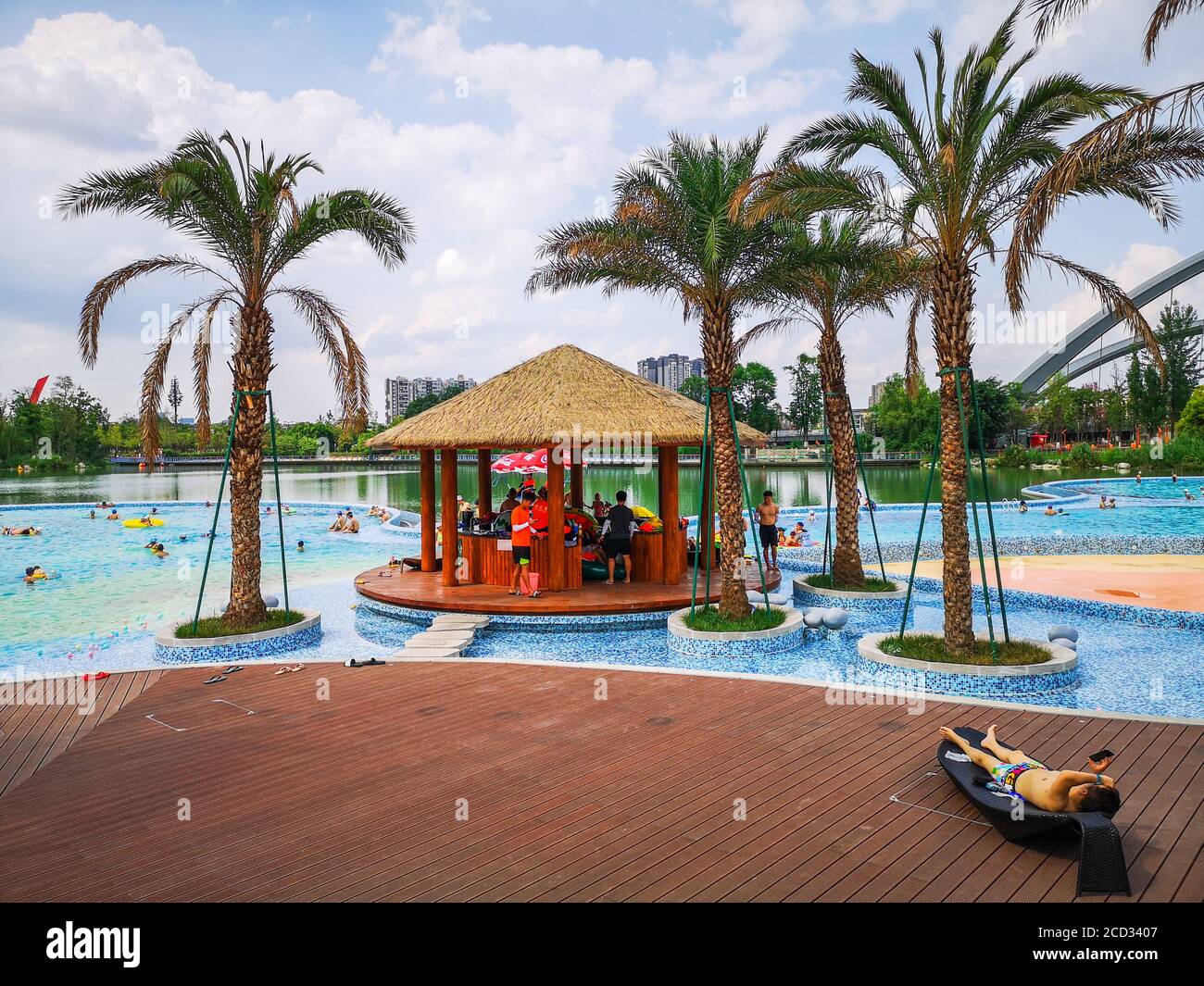 People swim at Sichuan's biggest outdoor swimming pool that is paved ...