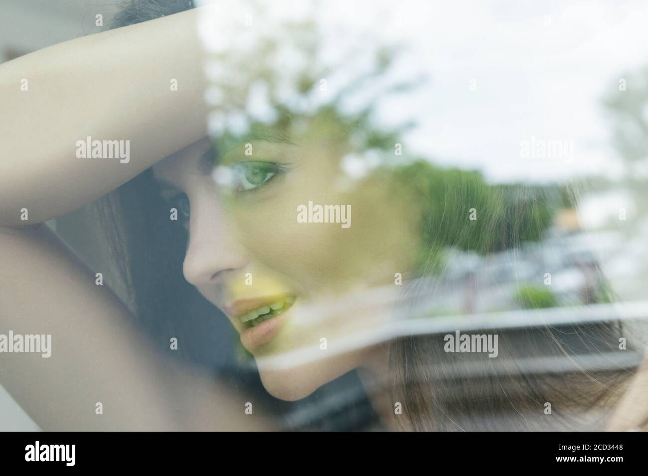 Portrait of beautiful woman, captured through the window glass Stock ...