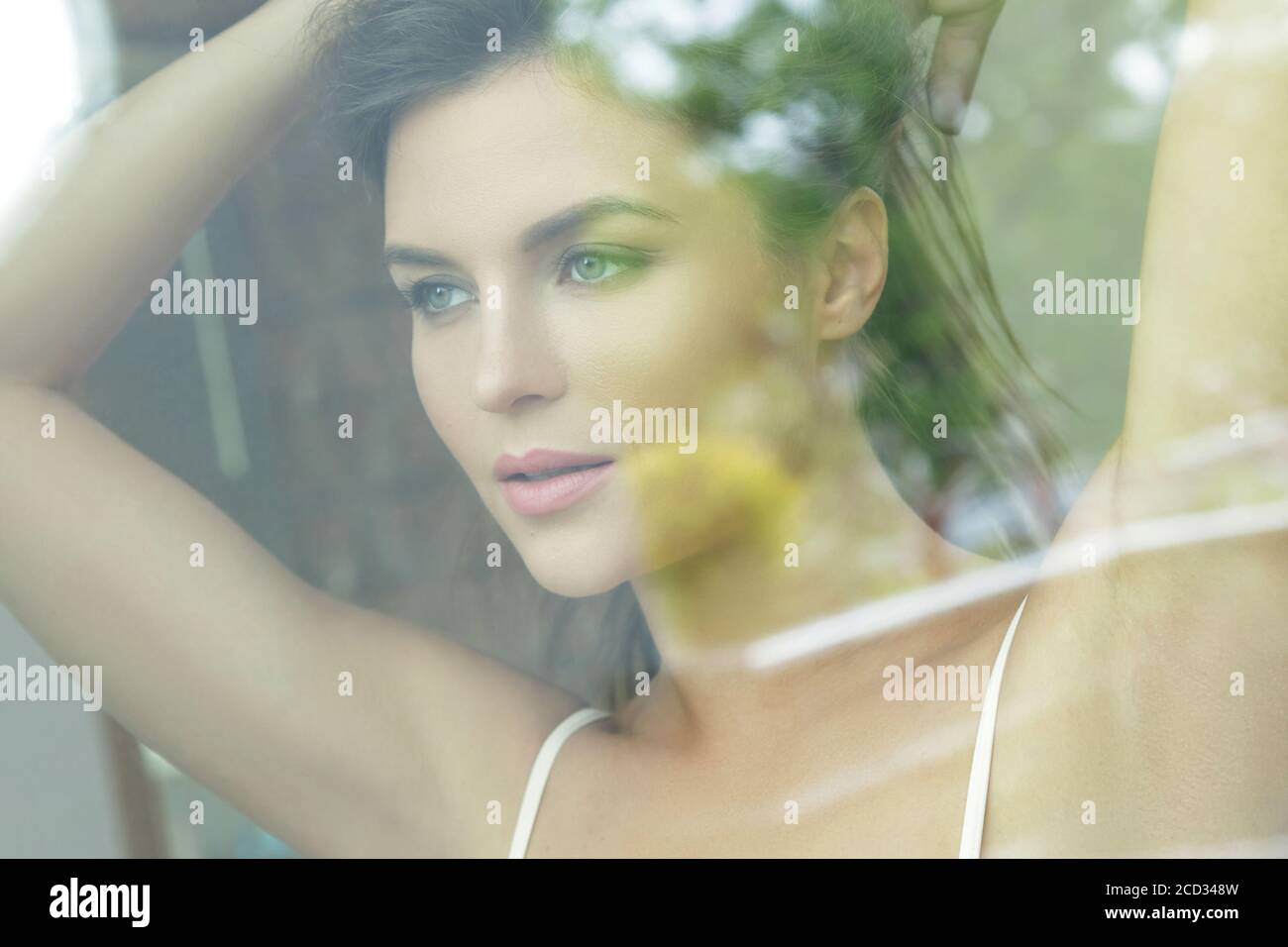Portrait of beautiful woman, captured through the window glass Stock ...