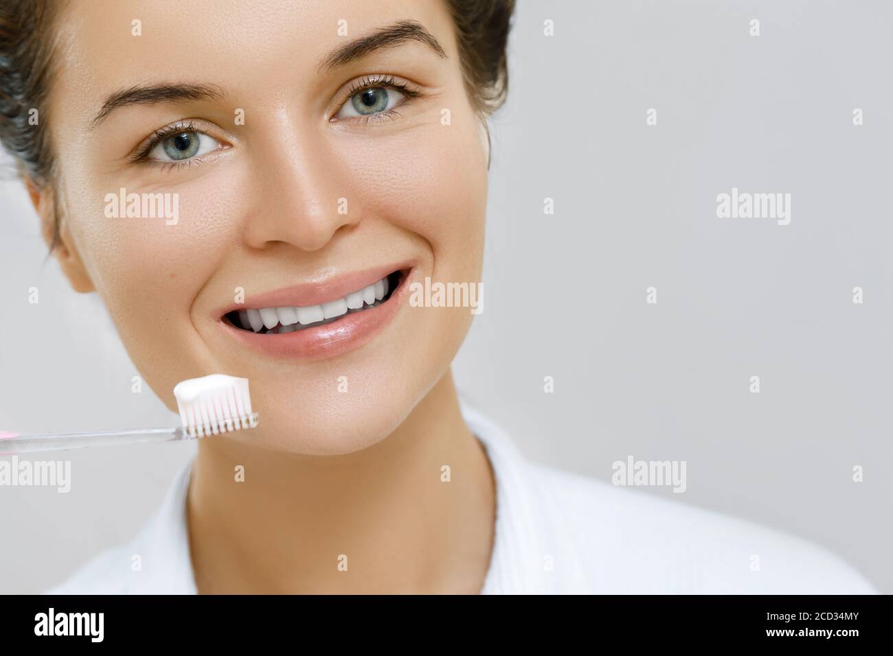 Woman cleaning her teeth in the bathroom Stock Photo - Alamy