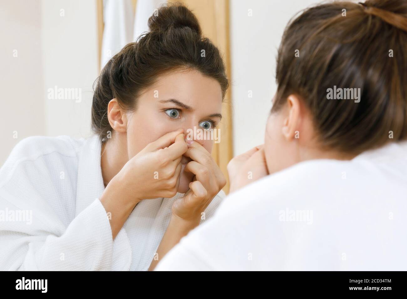 Woman squeeze pimples in the bathroom Stock Photo - Alamy