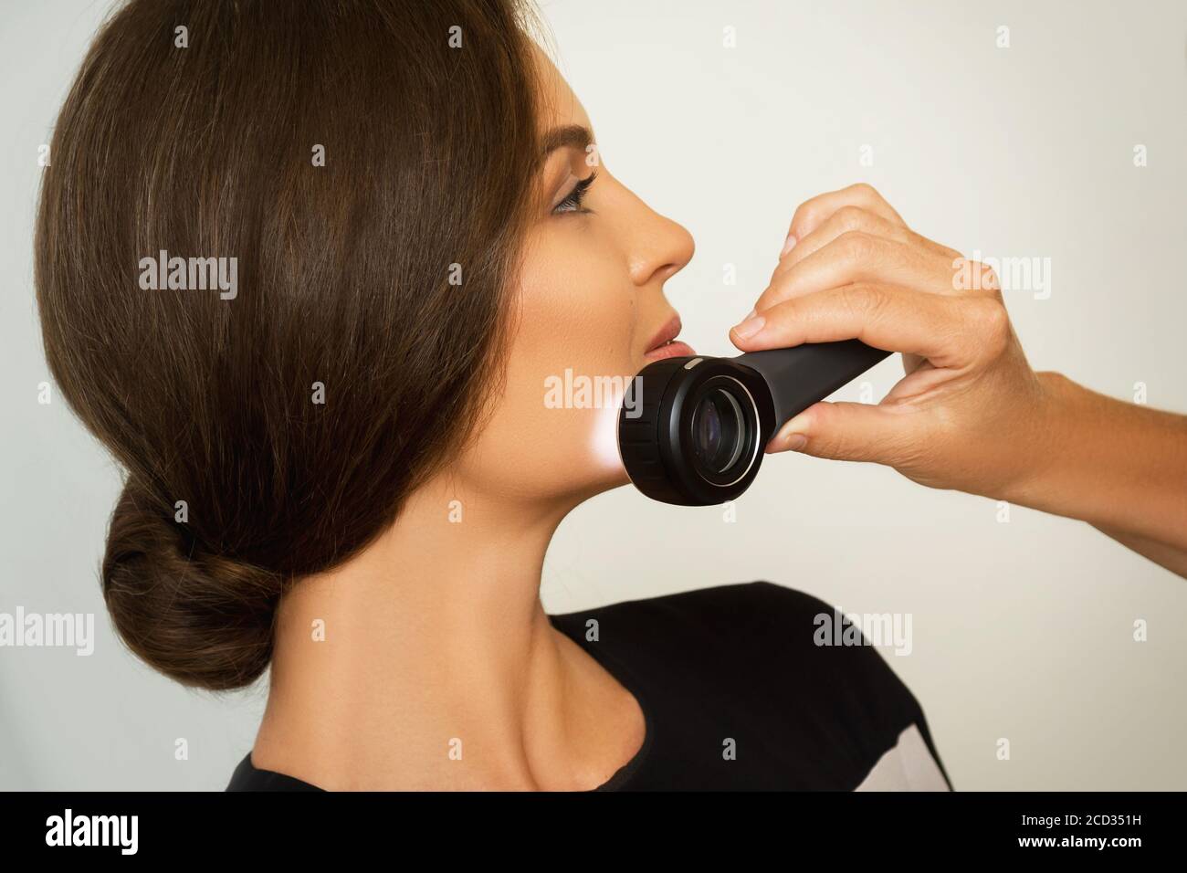 Doctor is checking facial skin condition through magnifying glass Stock ...