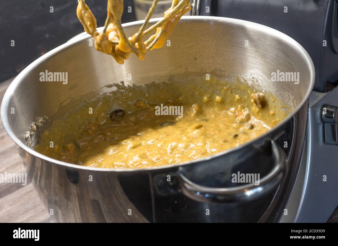 Raw muffin batter in electric mixer bowl with dough whisk suspended ...