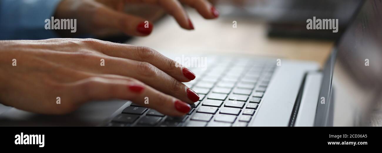 Woman with red nails is typing on keyboard Stock Photo - Alamy