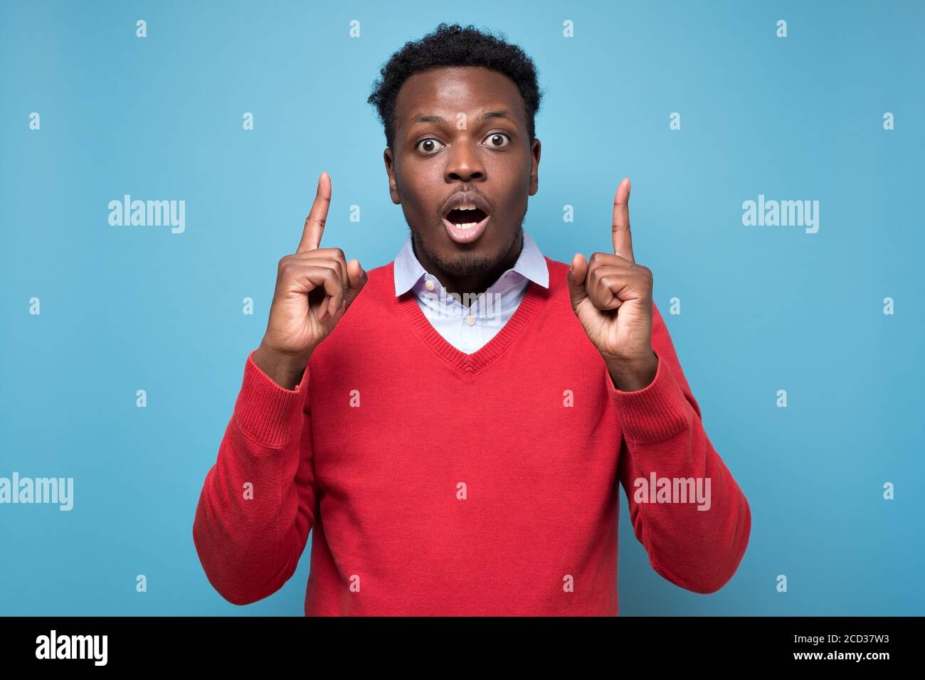 Surprised african man pointing up finger giving advice Stock Photo - Alamy