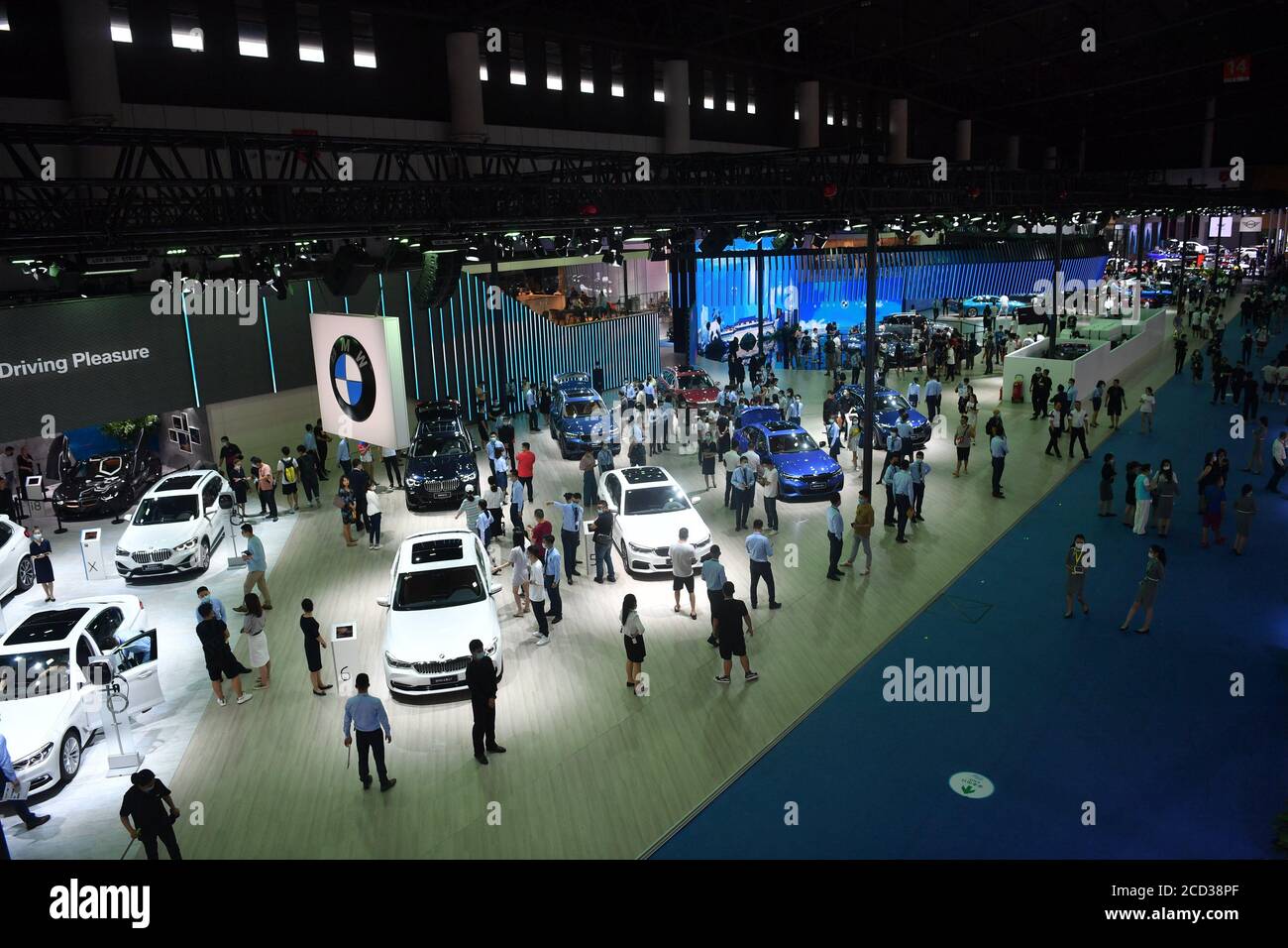 People look around at the cars exhibited at the opening ceremony of ...