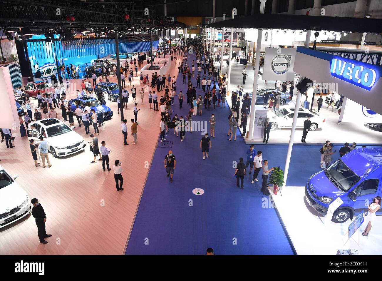 People look around at the cars exhibited at the opening ceremony of ...