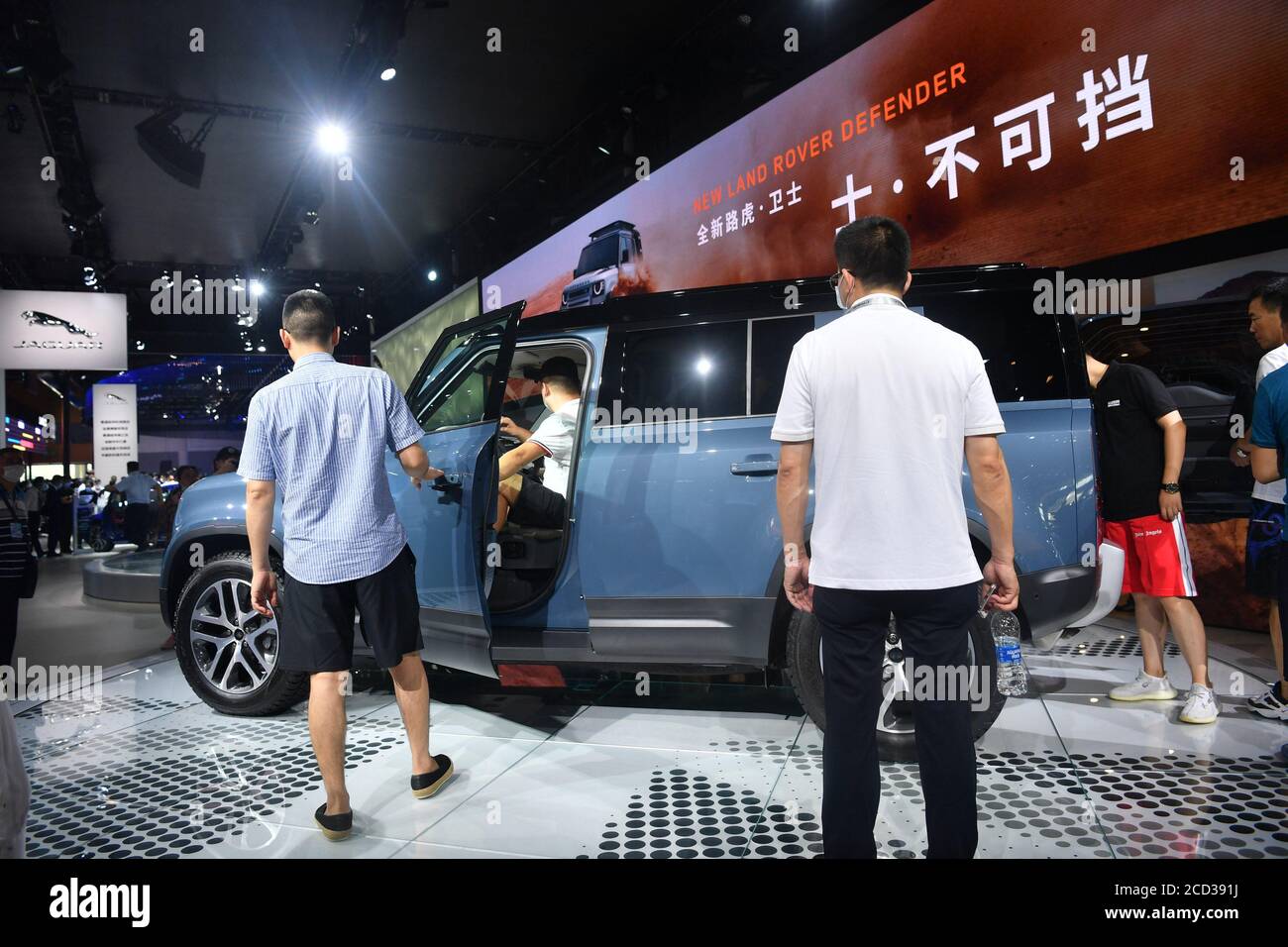People try a Rover car exhibited at the opening ceremony of 2020 ...