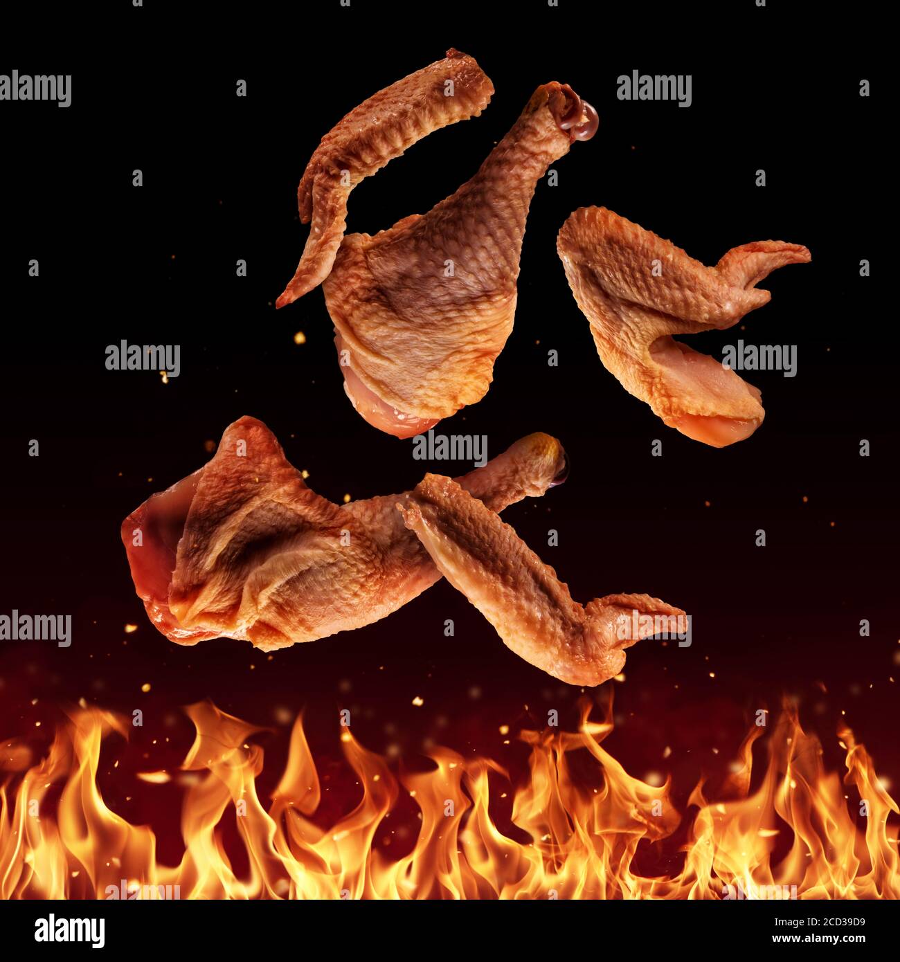 Flying raw chicken pieces above grill flames, isolated on black ...