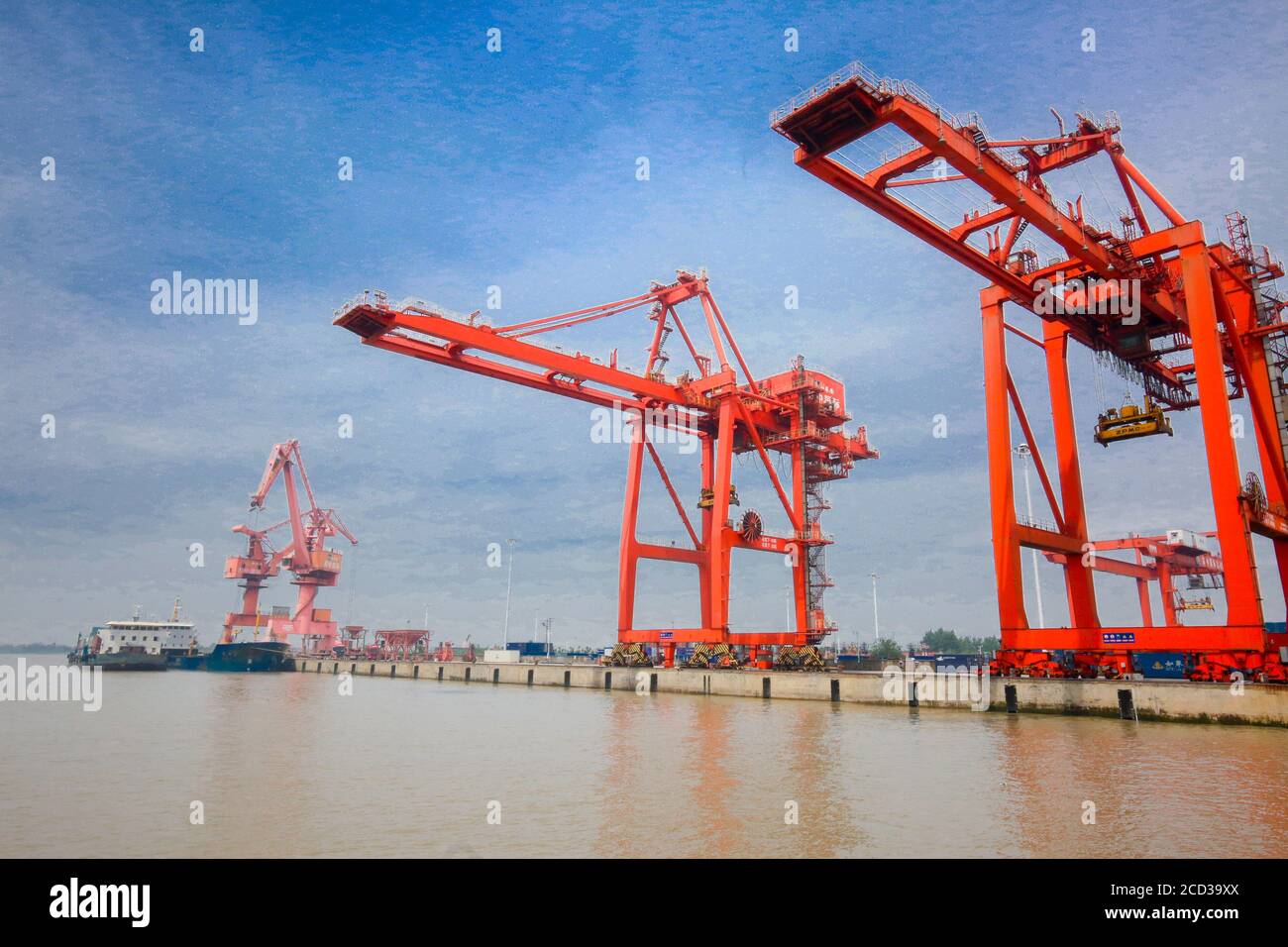 An aerial of cranes standing and containers arrayed at the Rugao port ...