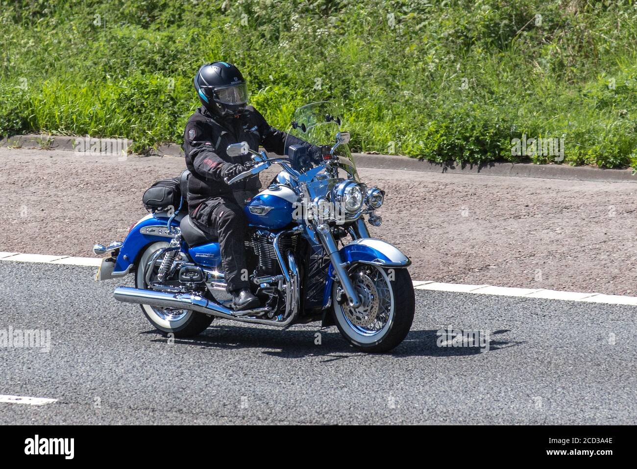 Blue Triumph Motorbike rider; two wheeled transport, motorcycles ...