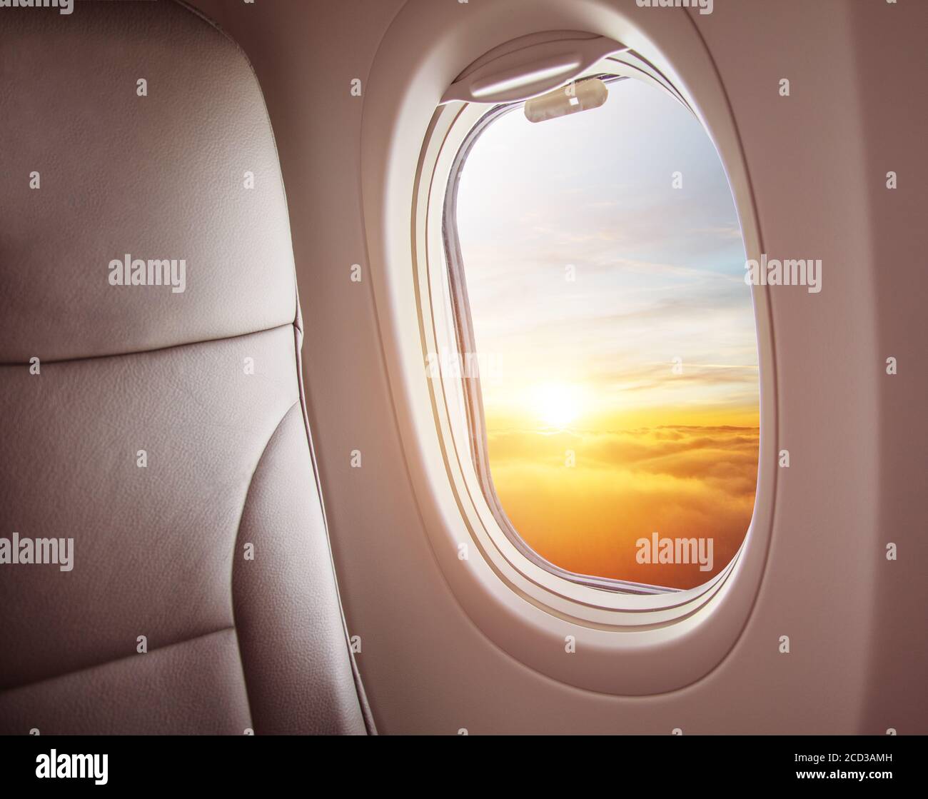 Airplane interior with window view of sunset above clouds. Concept of ...
