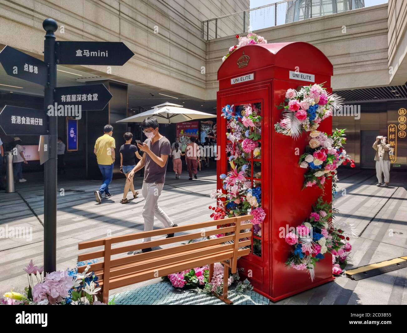 A phone booth, a trash bin and a Volkswagen Beetle fraught with flowers ...