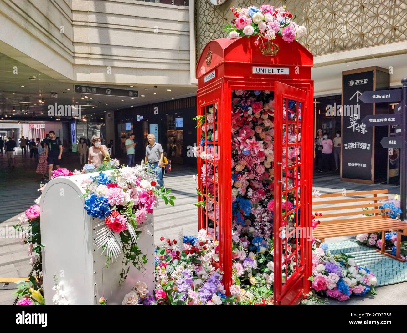 A phone booth, a trash bin and a Volkswagen Beetle fraught with flowers ...