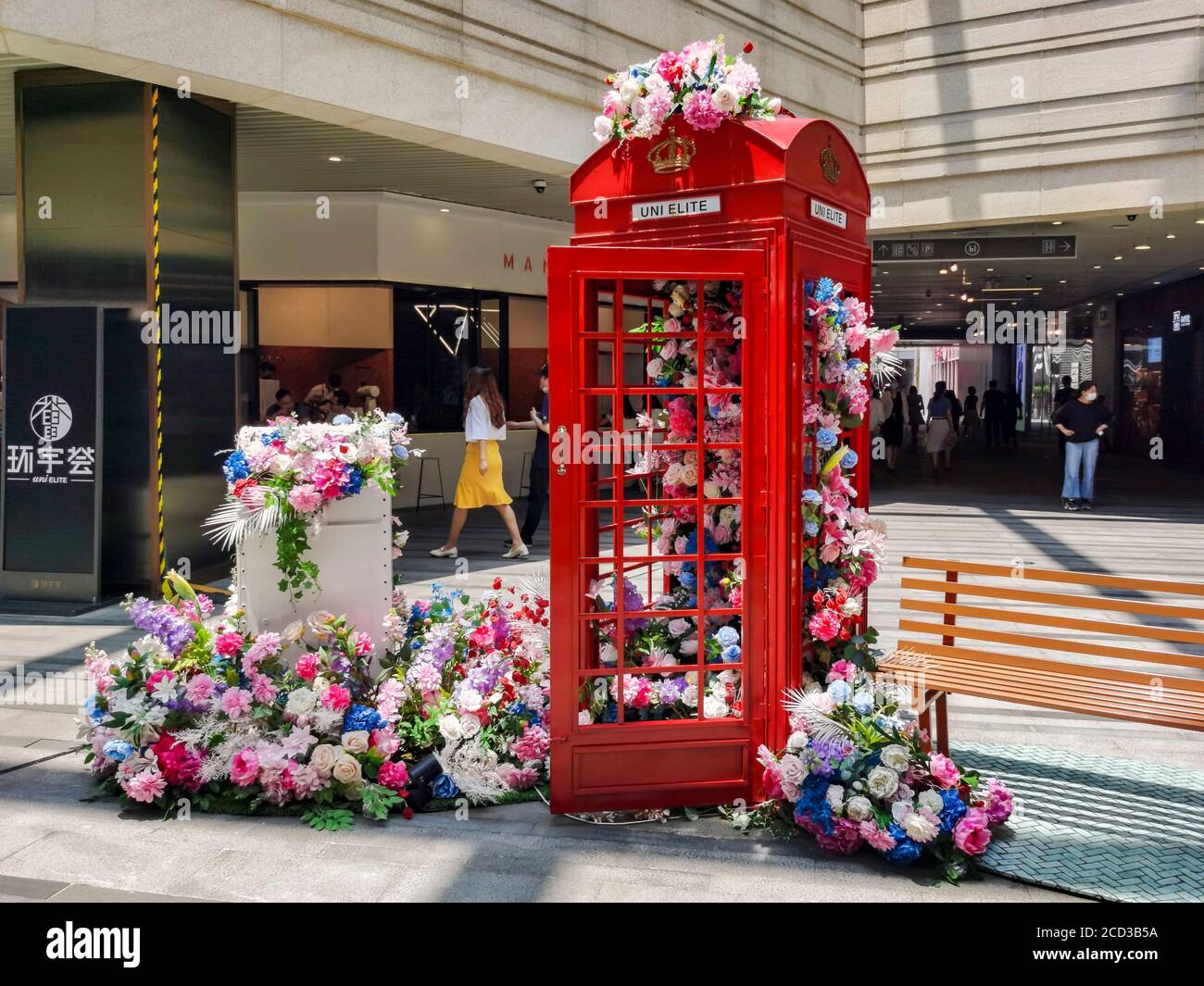A phone booth, a trash bin and a Volkswagen Beetle fraught with flowers ...