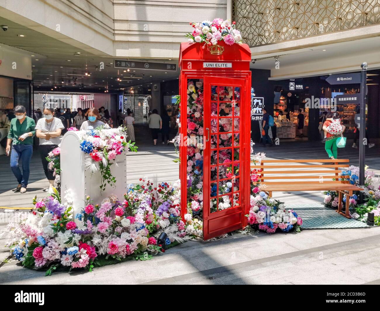 A phone booth, a trash bin and a Volkswagen Beetle fraught with flowers ...