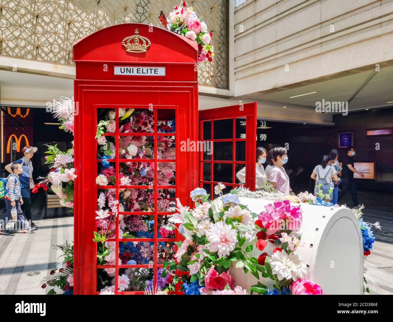 A phone booth, a trash bin and a Volkswagen Beetle fraught with flowers ...