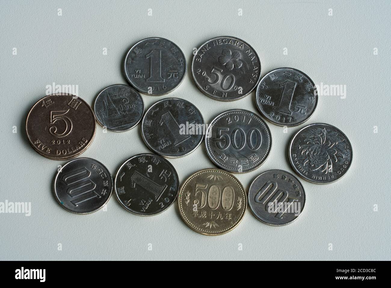 Coins from different countries and currency Stock Photo - Alamy