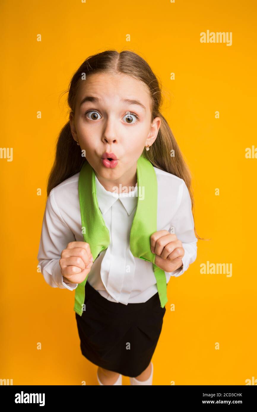 Surprised Elementary Student Girl Looking At Camera Posing In Studio ...