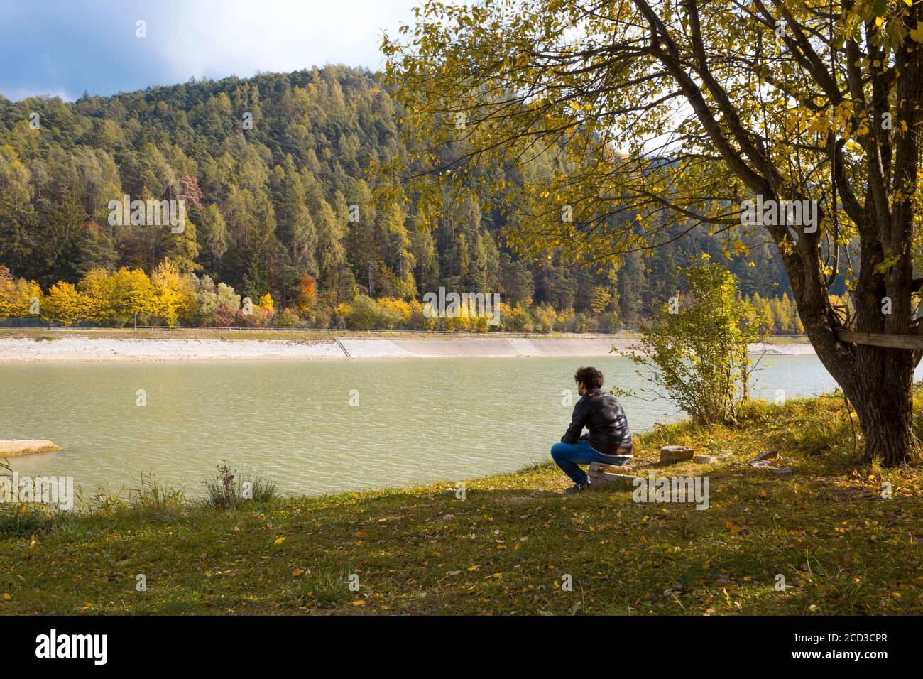 Boy sitting under tree in hi-res stock photography and images - Alamy