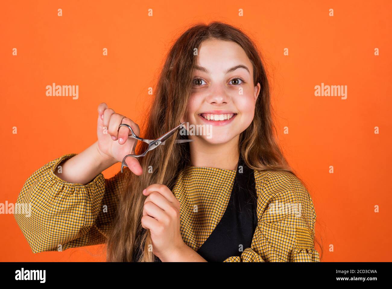 teen girl cut her hair with scissors. making new hairstyle. kid use ...