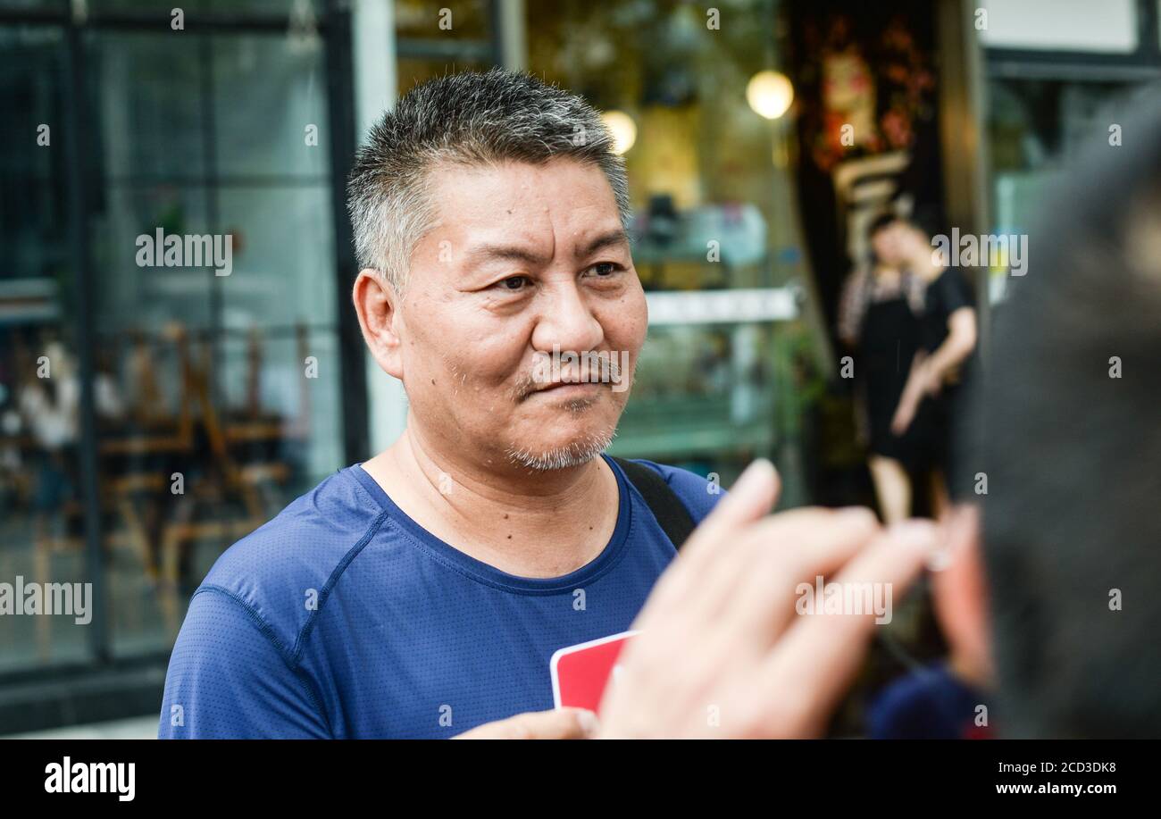 53-year-old Chinese man Liang Shi steps out of the testing center ...