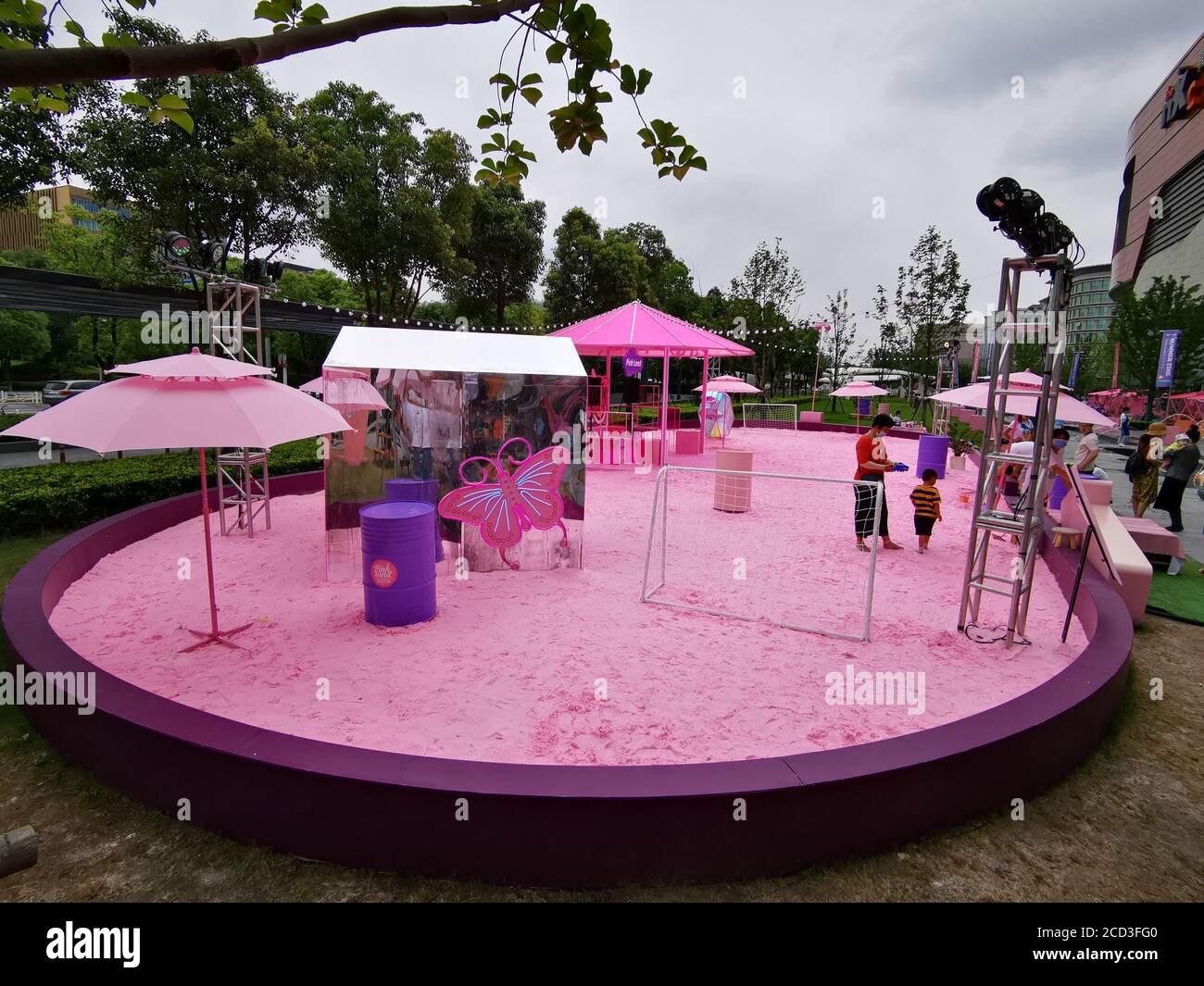 Customers play around the pink beach, which is composed of pink sands ...