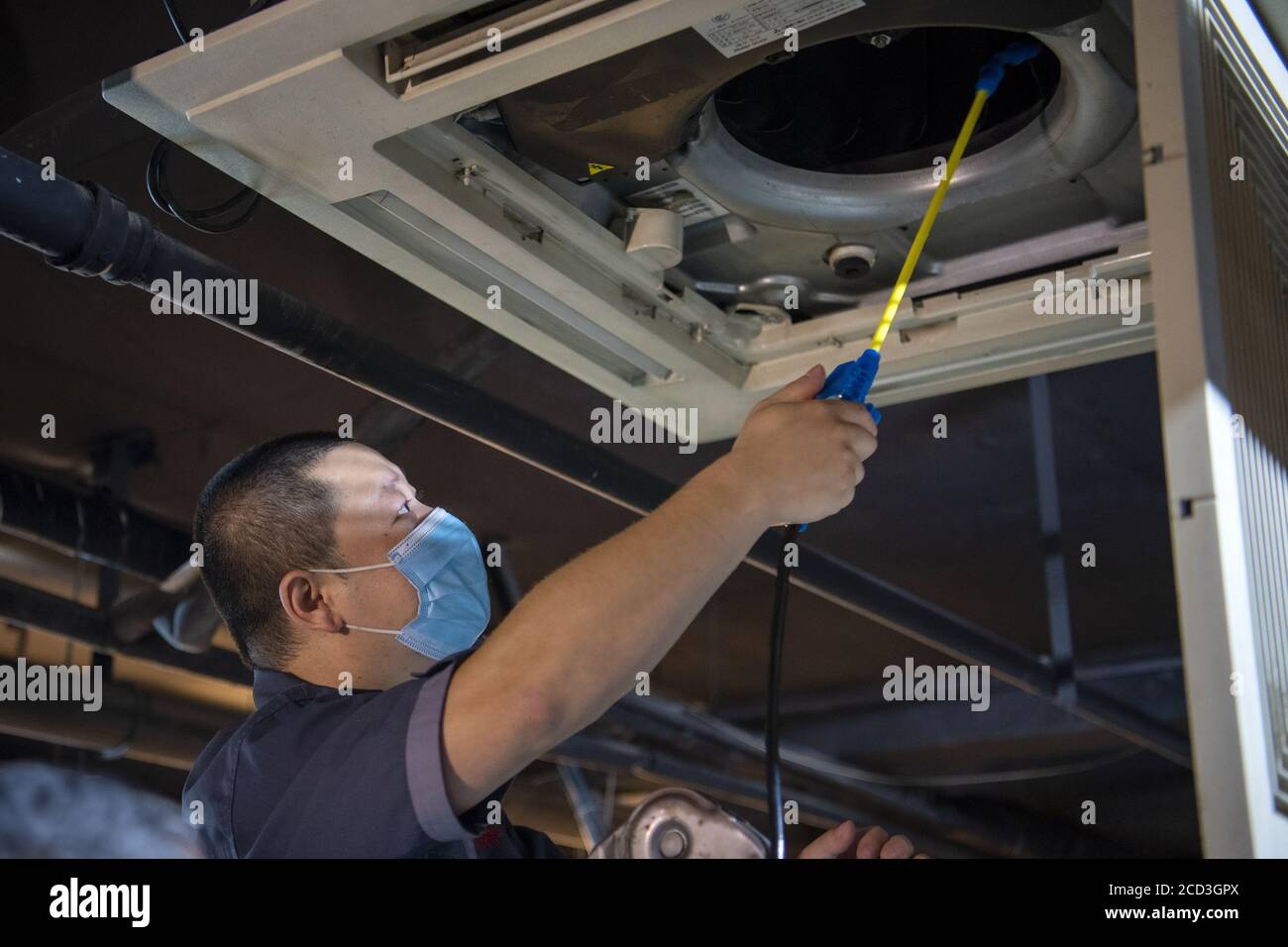 Staff check machines at a local cinema, preparing to show movies to the ...