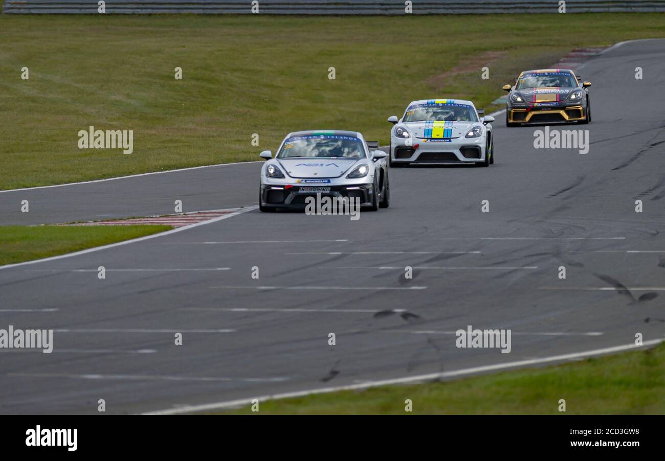 A shot of several racing cars as they circuit a track Stock Photo - Alamy